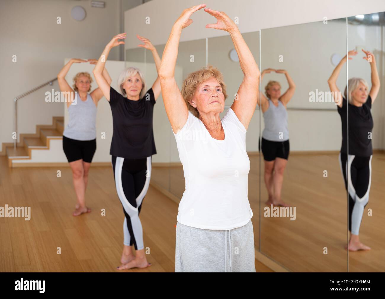Elderly woman practicing ballet dance moves in choreographic studio ...