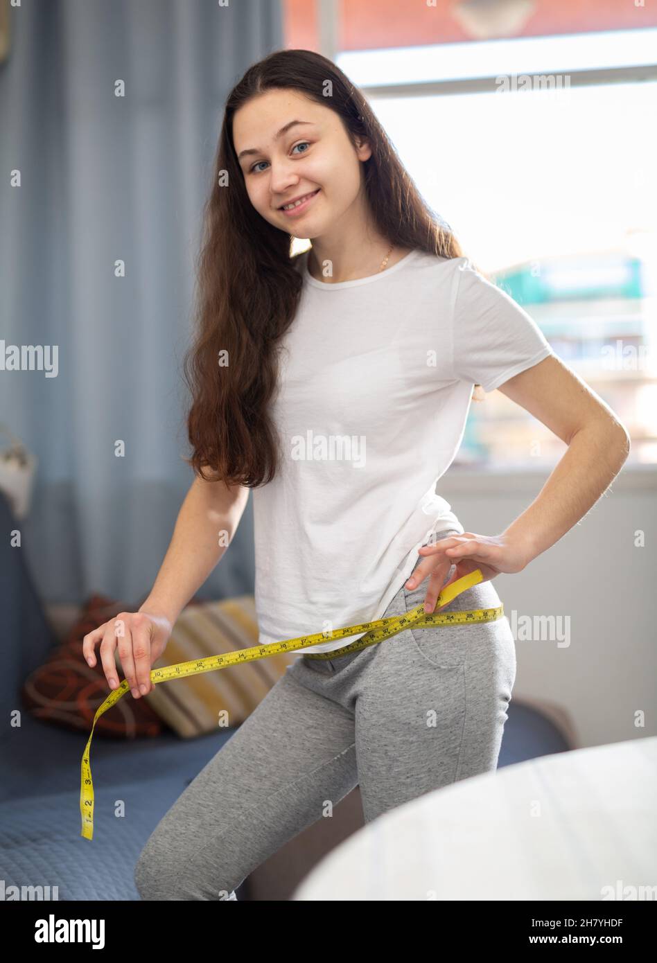 Young woman taking body measurements hi-res stock photography and ...