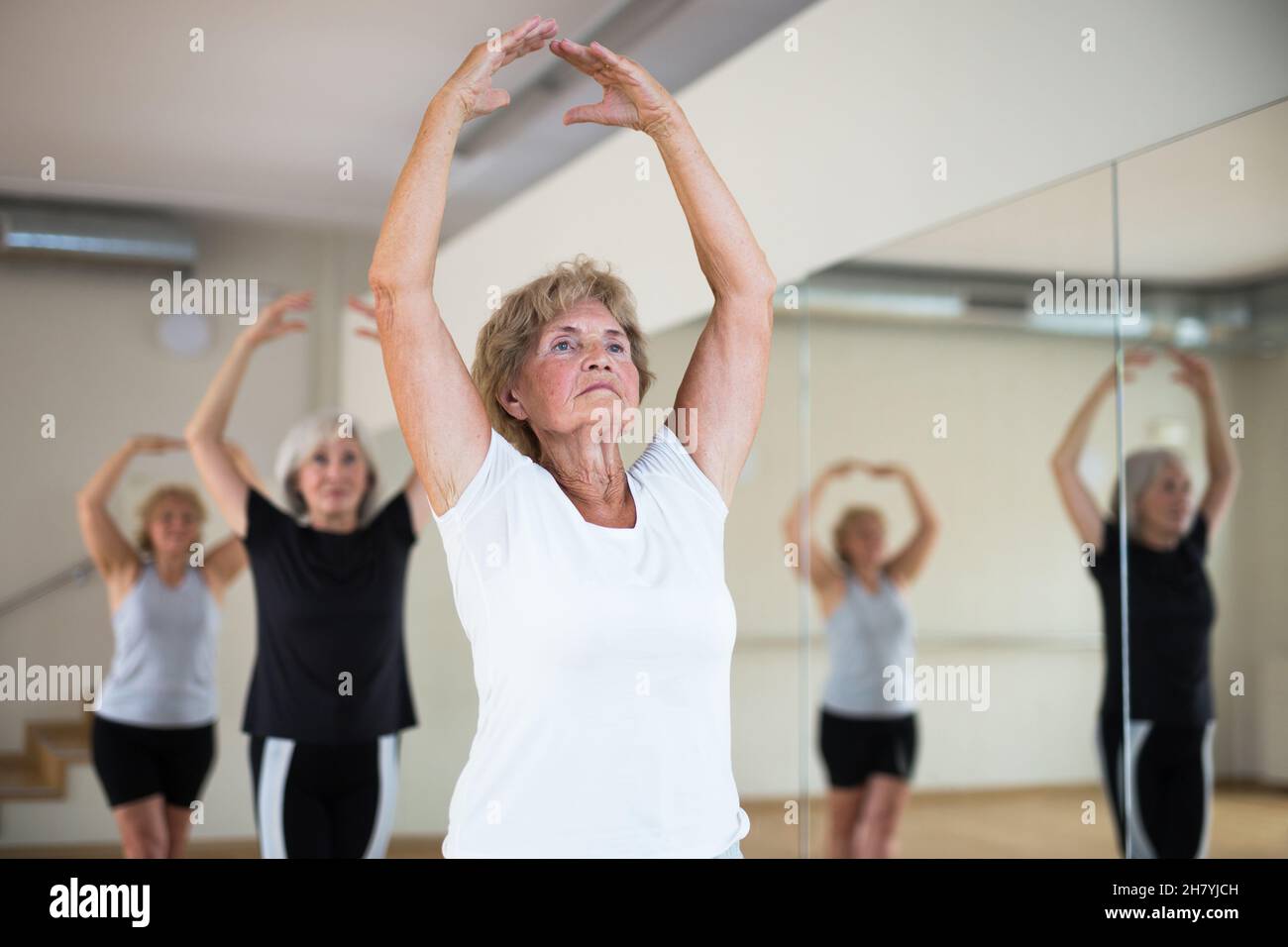 Senior woman practicing classical ballet technique in choreography ...
