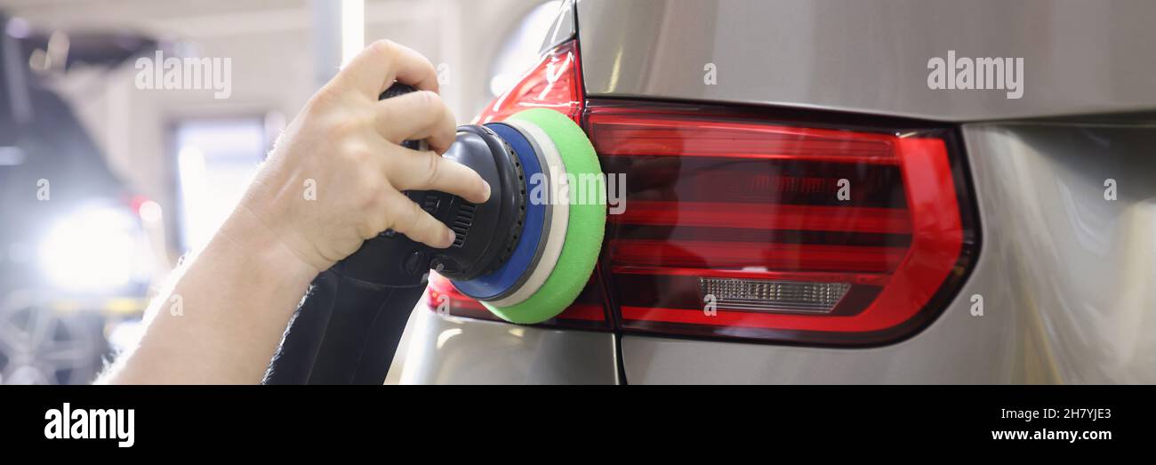 Cleaning rear lights on car from scratches with polishing machine Stock ...