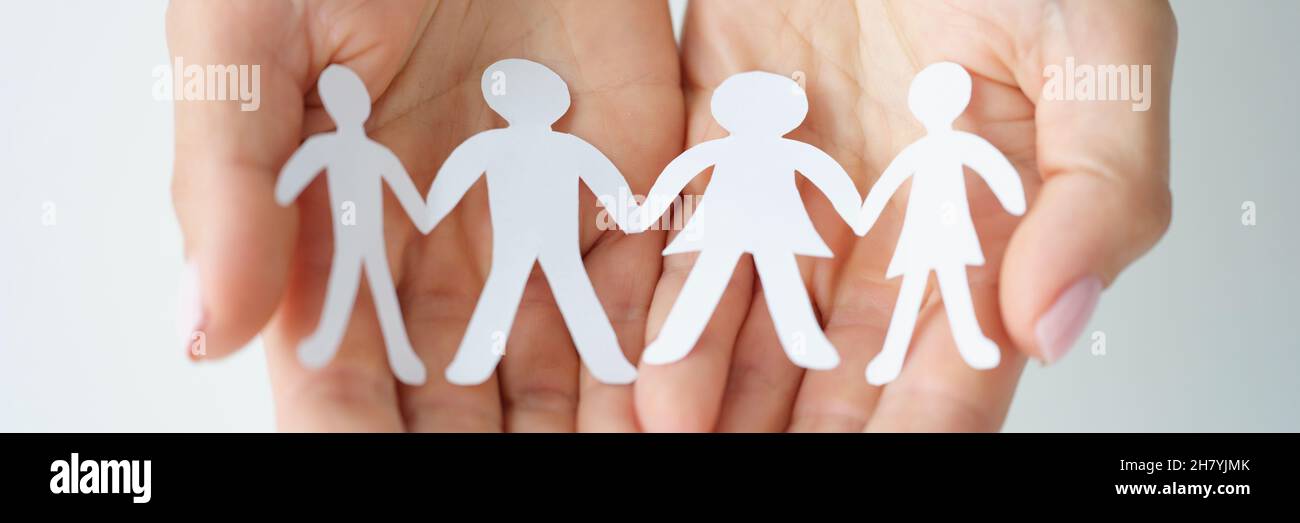 Man holding human paper figures hi-res stock photography and images - Alamy