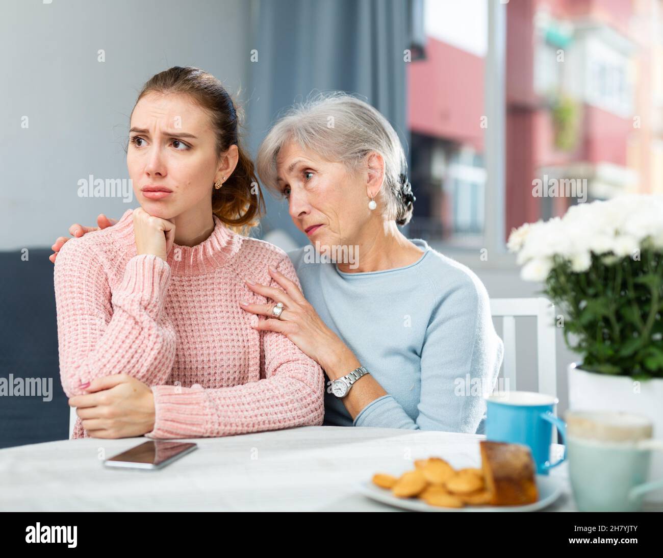 Mother encouraging her depressed adult daughter Stock Photo - Alamy
