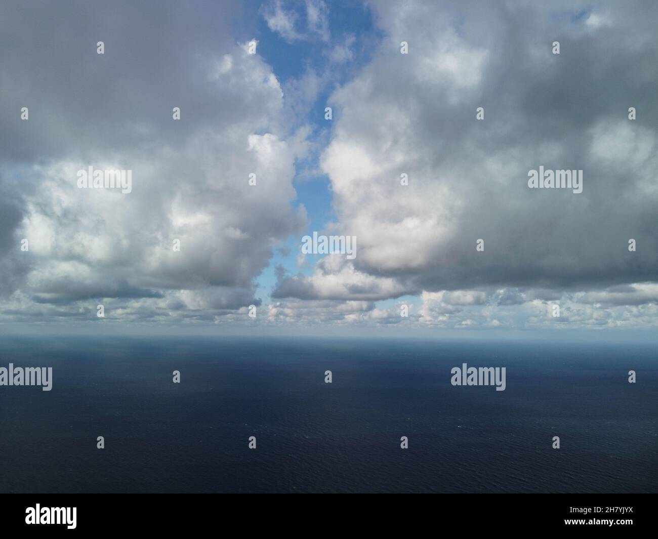 Abstract airy sky with moving plump clouds over the sea ocean. Small ...