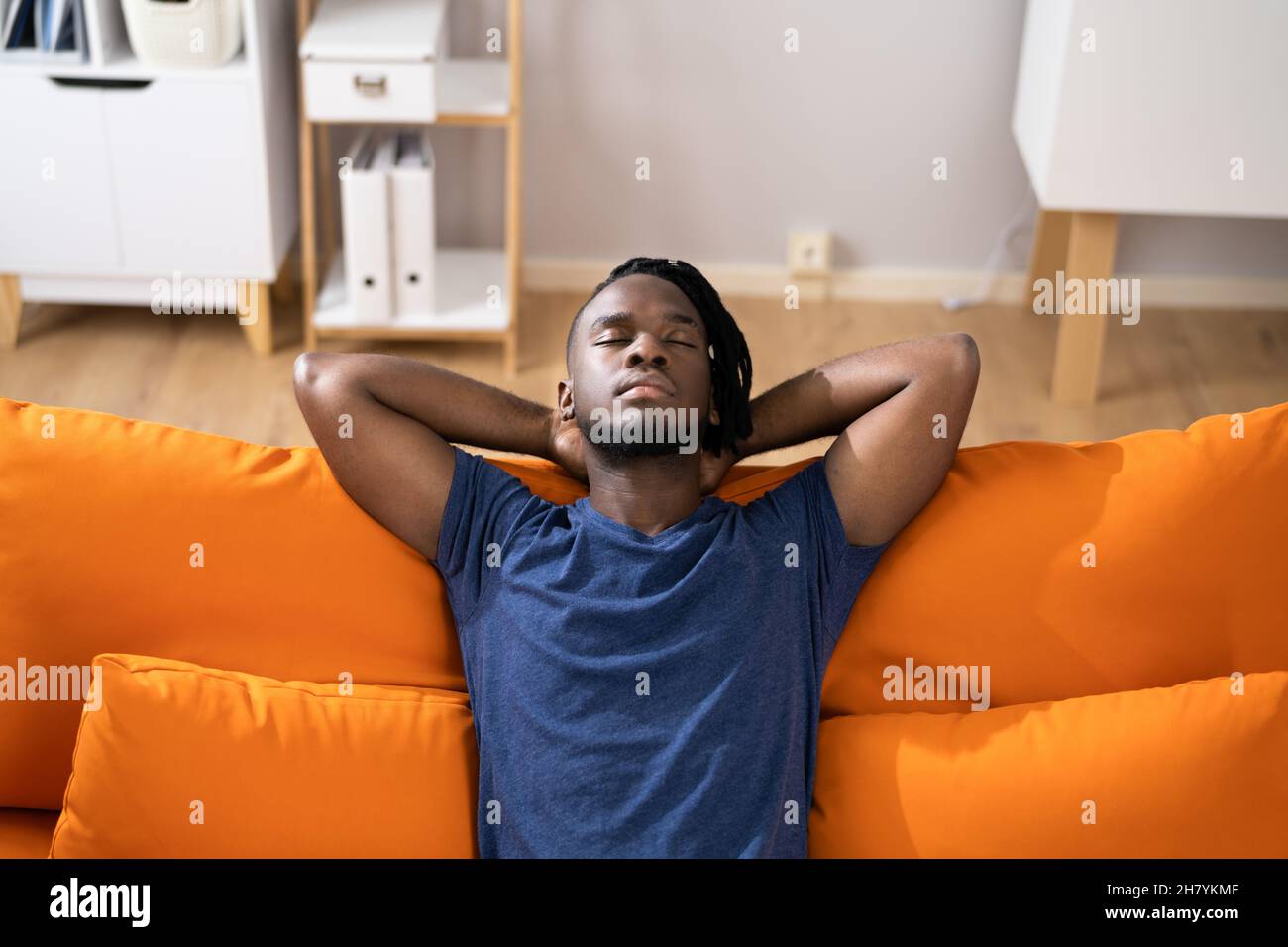Black man resting on couch hi-res stock photography and images - Alamy