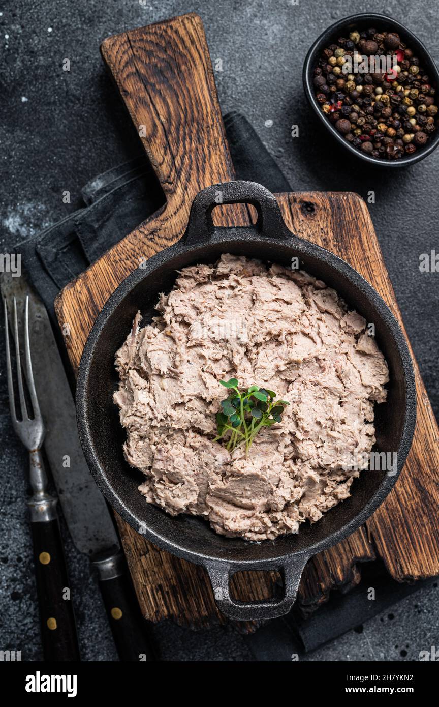 Duck pate Rillettes de Canard in a pan with greens. Black background ...