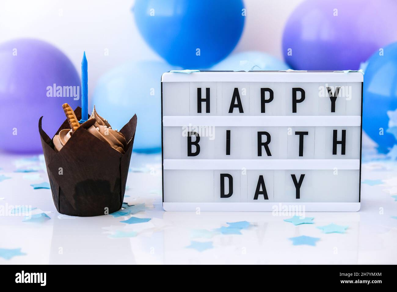 Lightbox with text HAPPY BIRTHDAY and chocolate cupcake candle on ...
