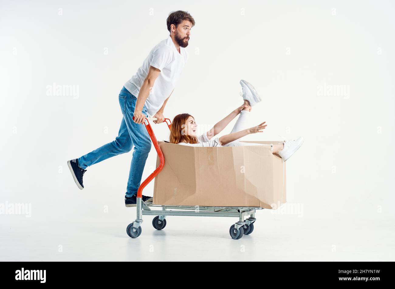 a young couple ride a cart entertainment isolated background Stock ...