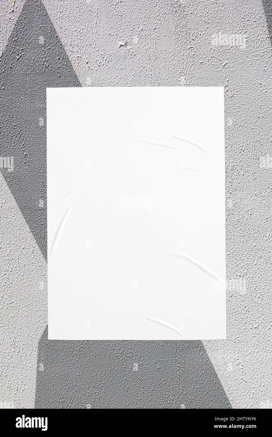 gray painted urban wall with wrinkled glued poster template Stock Photo ...