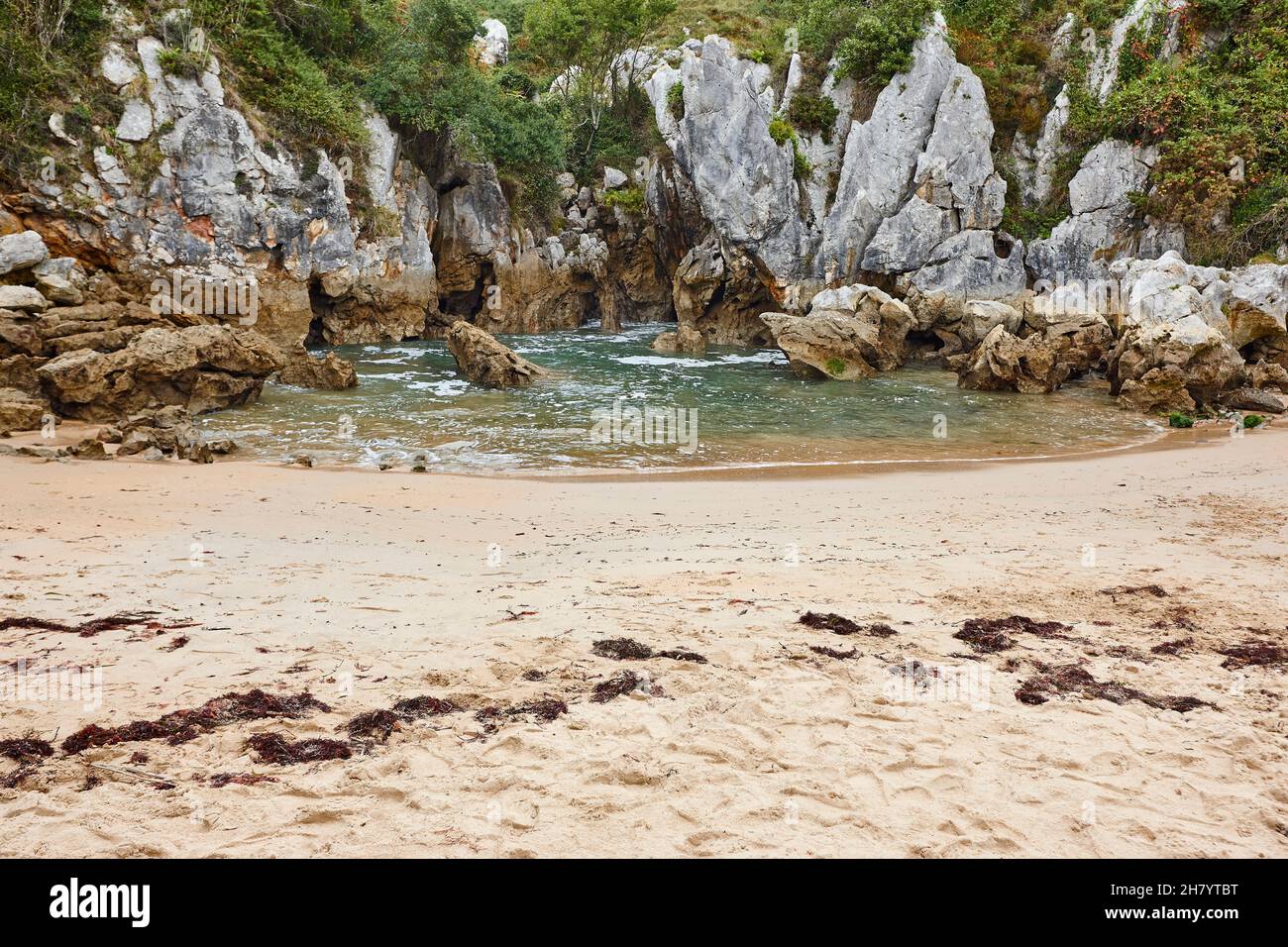 Picturesque inlet sand and rocky beach in Asturias, Gulpiyuri. Spain ...