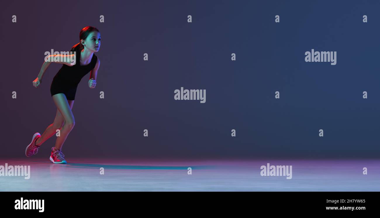 Full-length portrait of teen girl, athlete running, training isolated ...