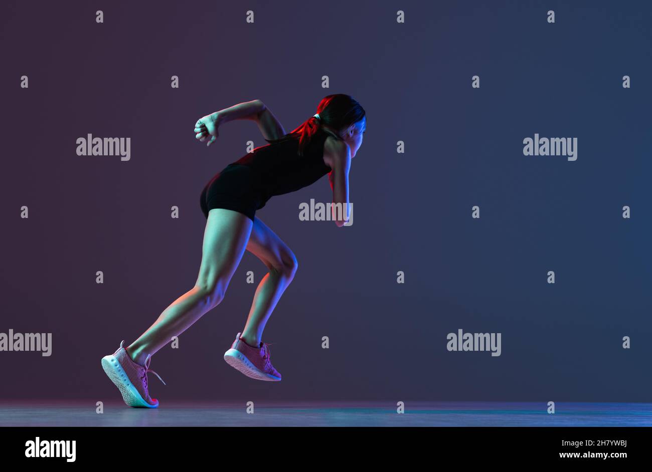 Full-length portrait of girl runing, training isolated over gradient ...