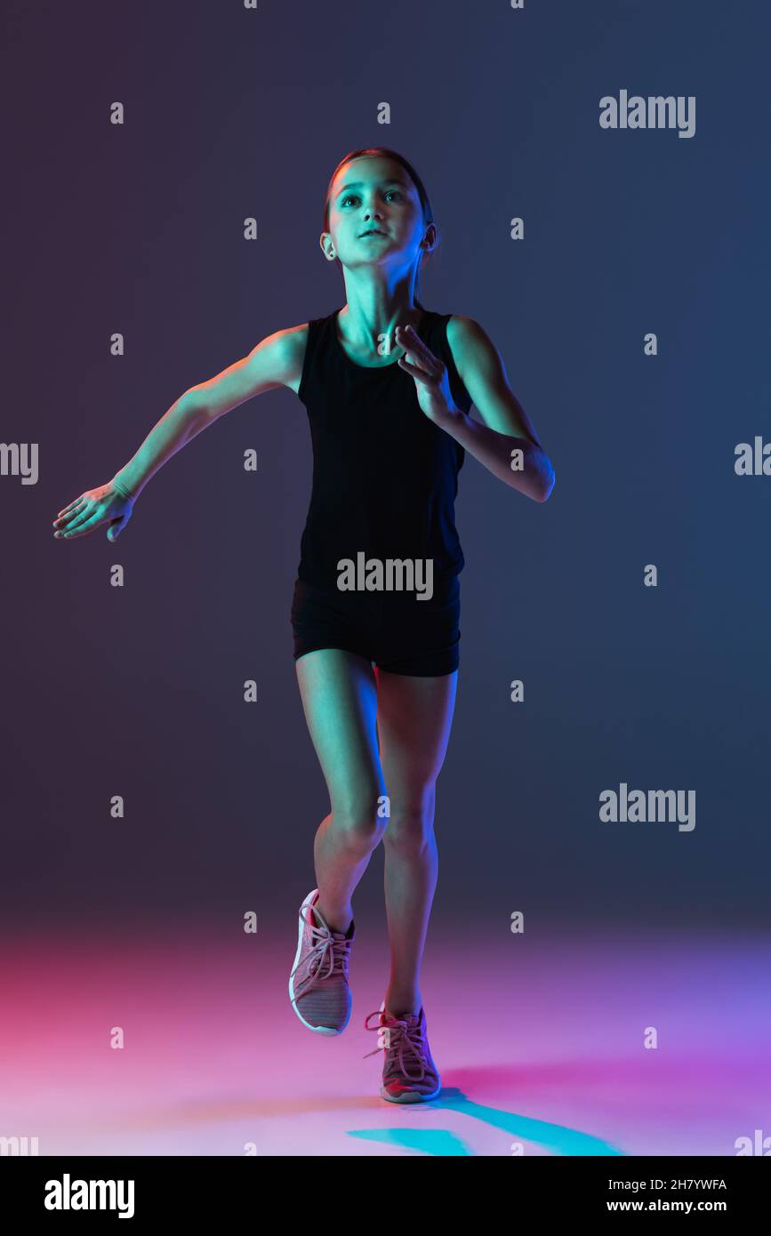 Front view portrait of teen girl, professional athlete running ...