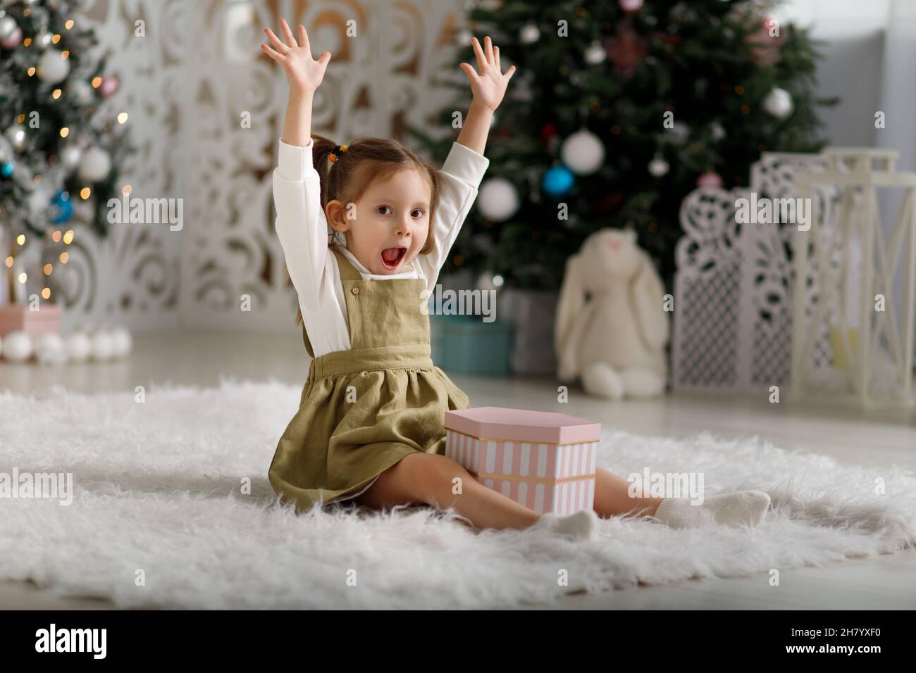 Nice pleased merry delight emotional cute girl with new year gift while ...