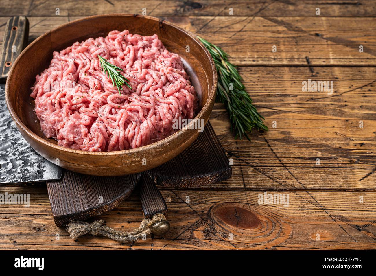 Chicken or turkey mince meat, raw Poultry in a wooden plate. Wooden ...