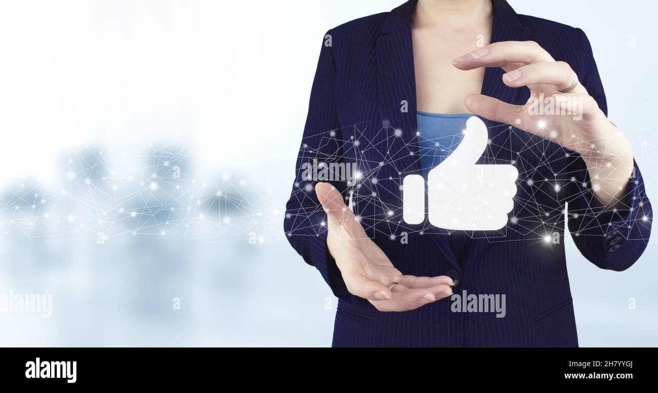 Tumb up concept. Two hand holding virtual holographic hand tumb up icon ...