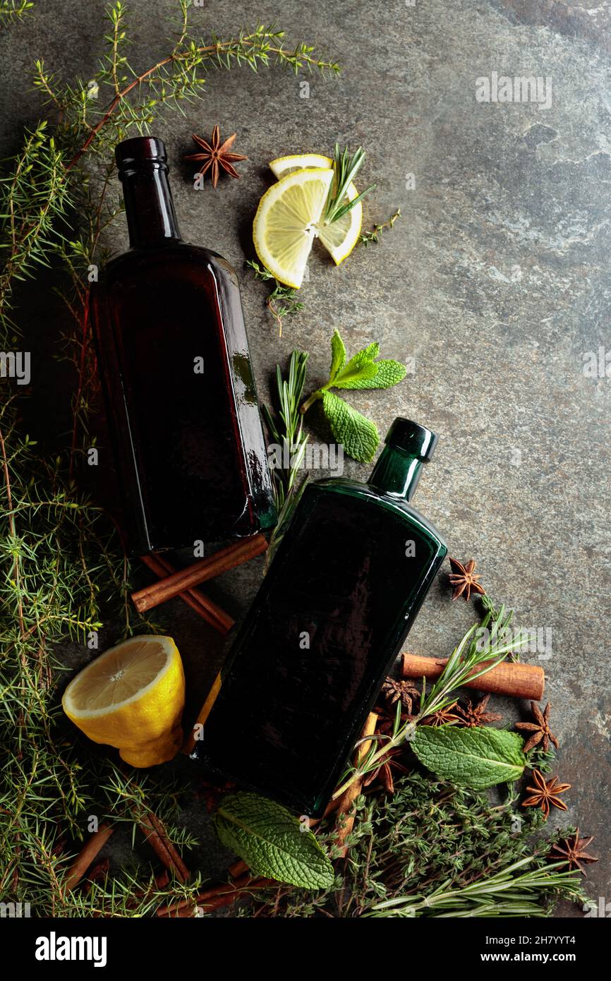 Vintage bottles of gin and various ingredients on an old stone ...