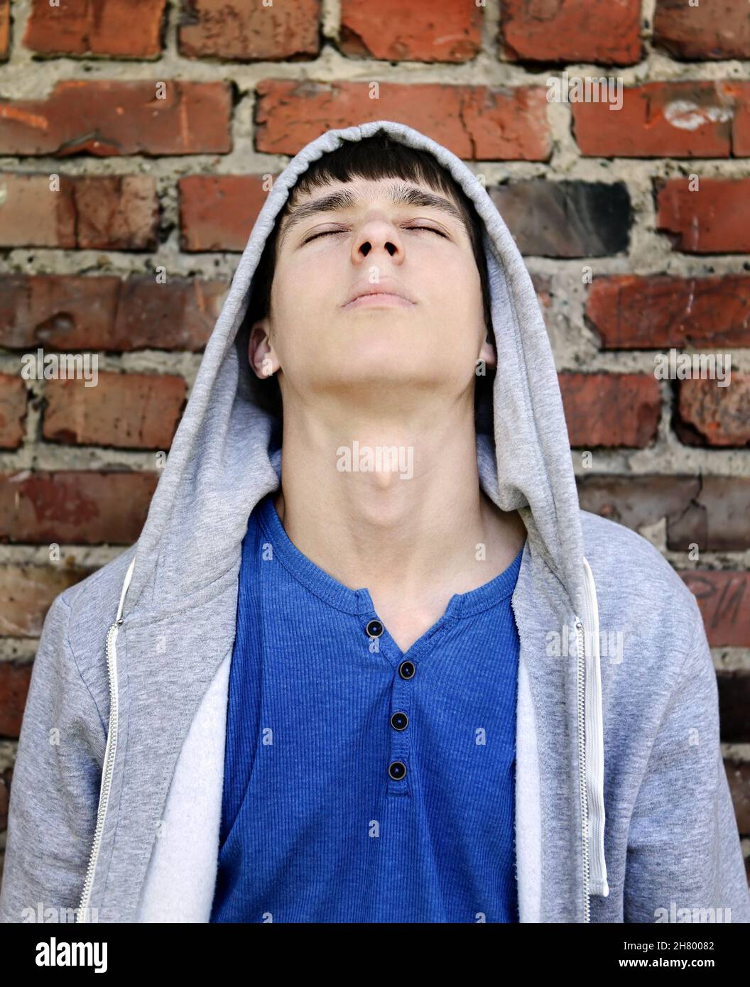 Portrait pensive young man front brick wall hi-res stock photography ...