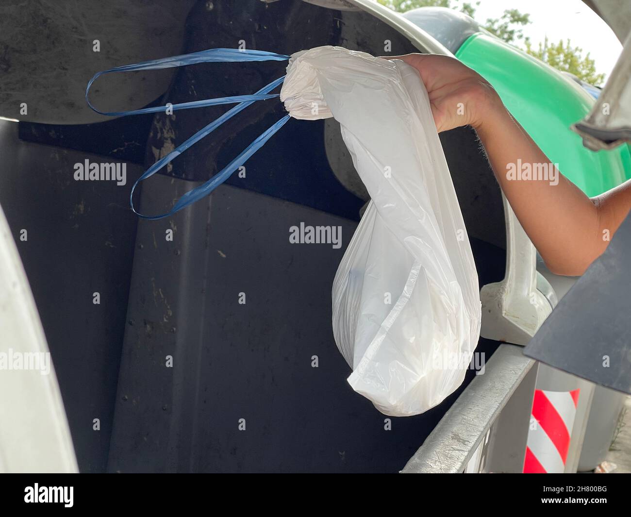 hands of a woman throughing trash to a dupster - sustainability and ...