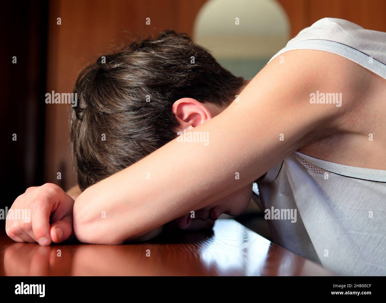 Young Man sleep on the Table in the Room closeup Stock Photo - Alamy