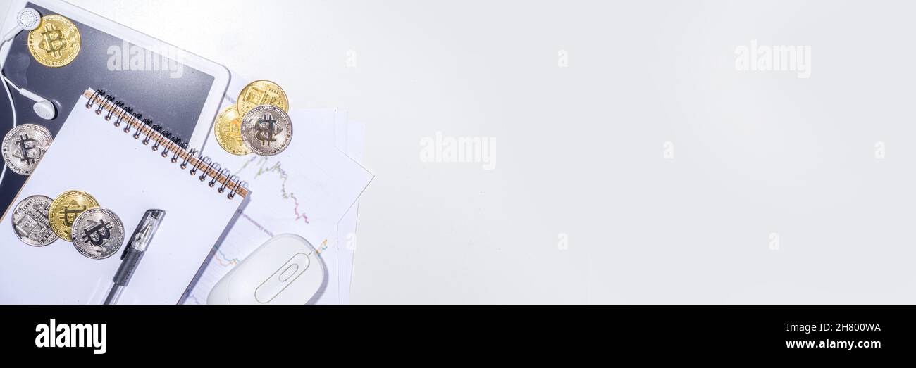 Bitcoin coins on office desktop workspace. Working with cryptocurrency ...