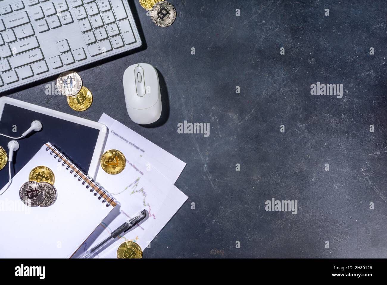 Bitcoin coins on office desktop workspace. Working with cryptocurrency ...