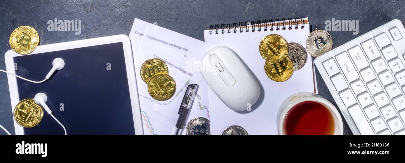 Bitcoin coins on office desktop workspace. Working with cryptocurrency ...