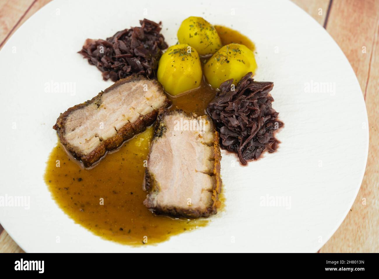 Pork Royal a traditional roast pork with red cabbage and potatoes Stock ...