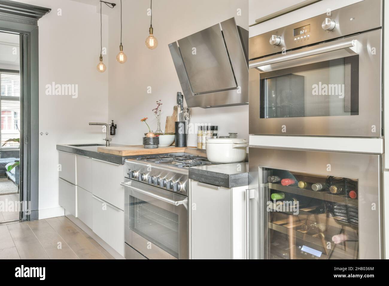 Kitchen counter with sink and modern gas stove with pot in light ...