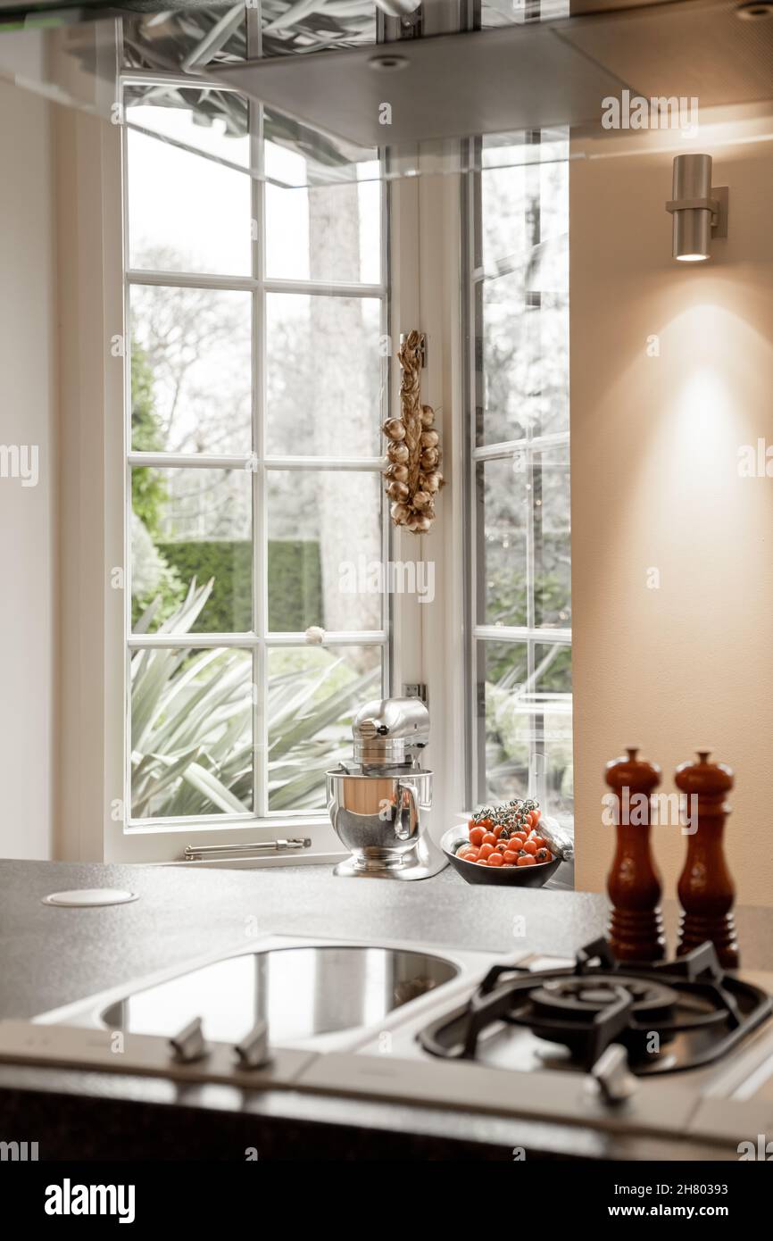 Modern kitchen near window with gas burner and induction hob on table ...