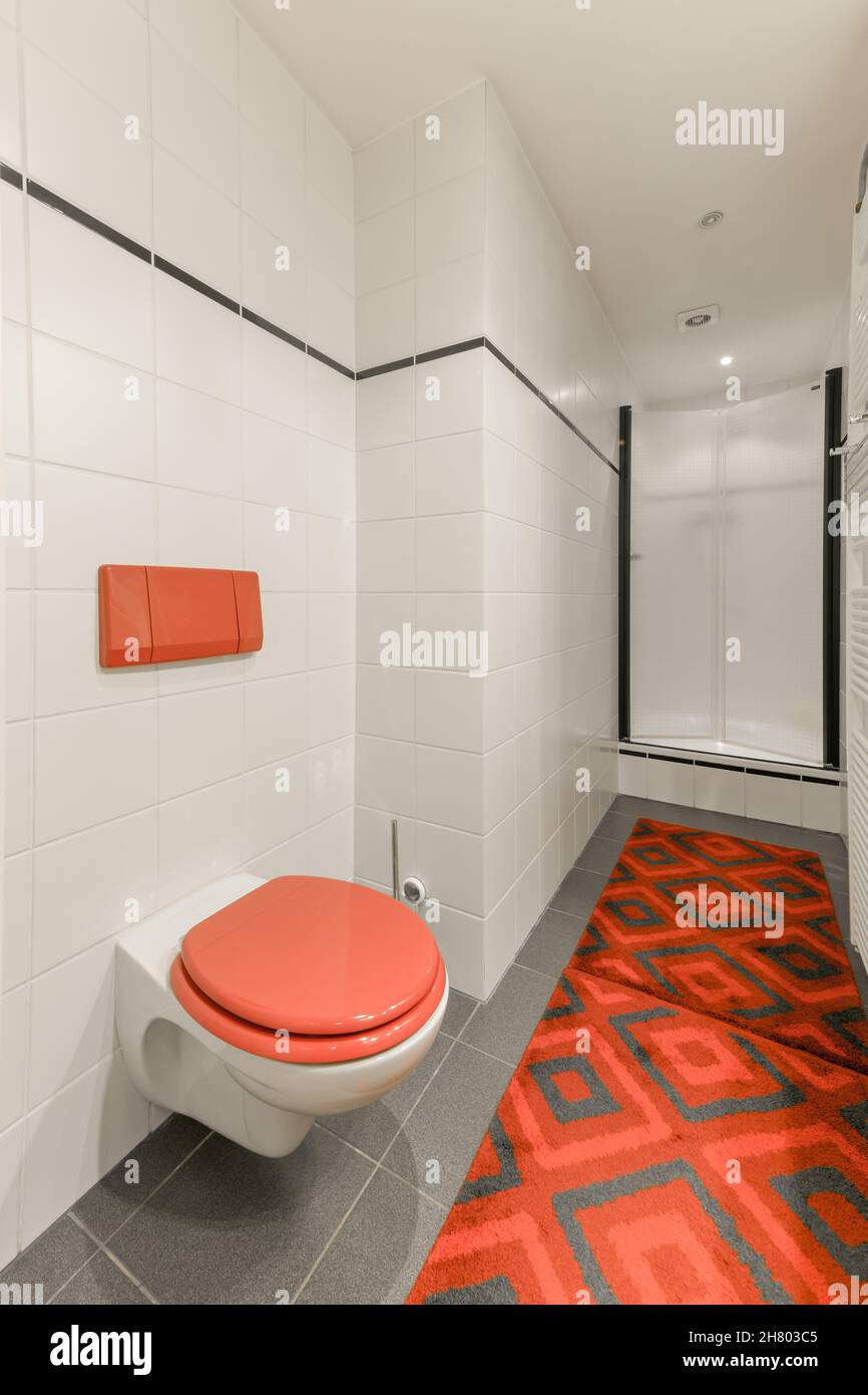 From above of interior of modern restroom with white tiled walls and ...