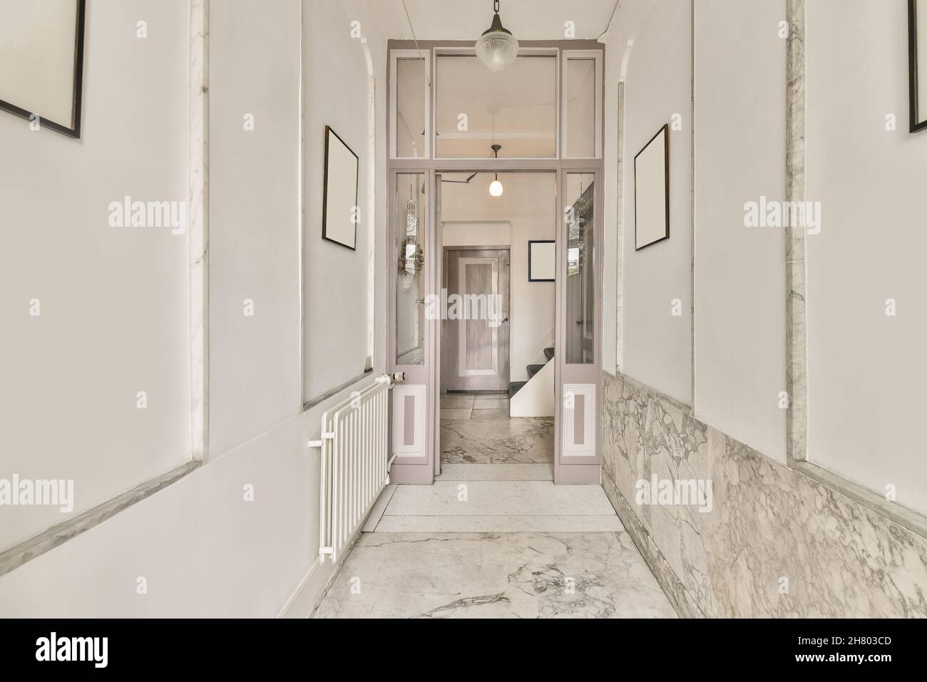 Long corridor with marble floor and various decorative frames hanging ...