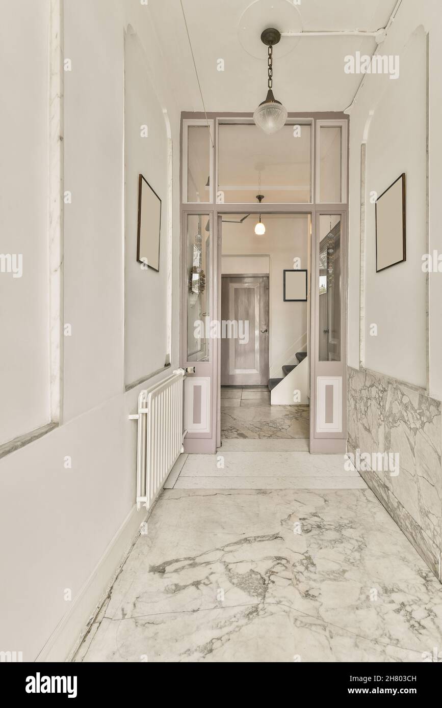Long corridor with marble floor and various decorative frames hanging ...