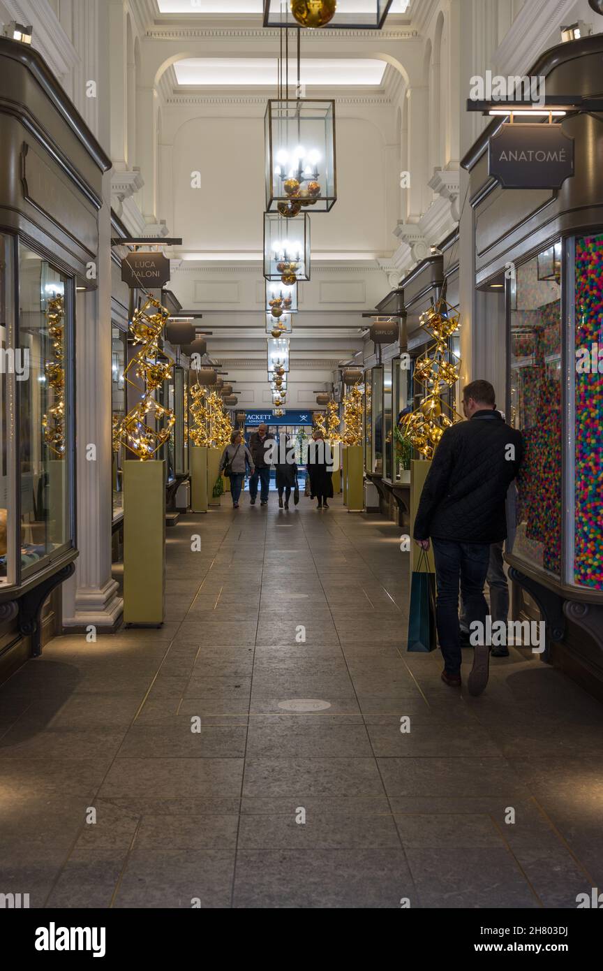 People out shopping walk through Princes Arcade. Christmas decorations ...