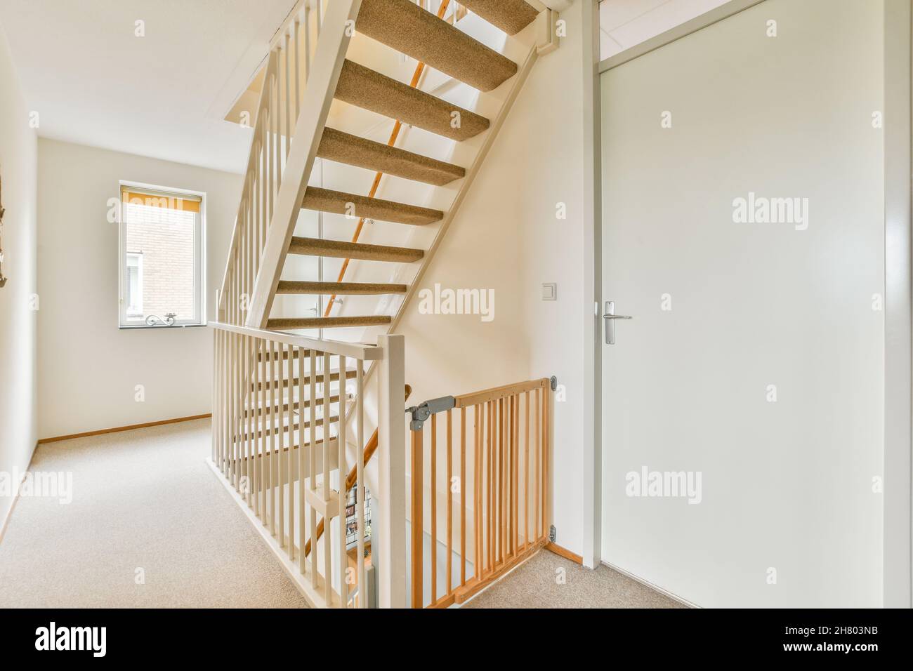 Stairway with wooden steps and railings placed in corridor of light ...