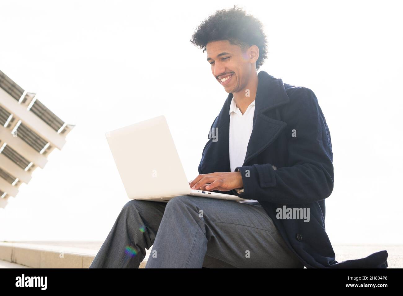 Positive African American male freelancer with Afro hairstyle dressed ...