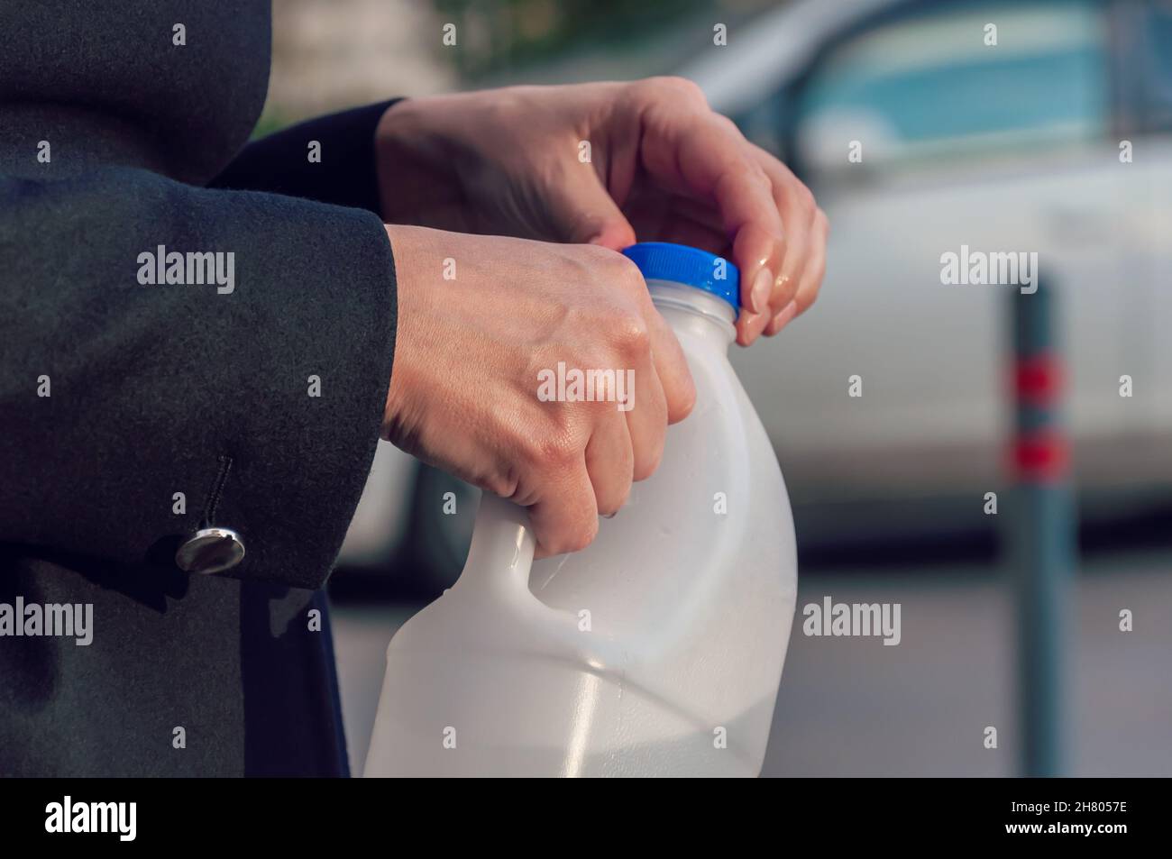 Woman clasping cap of a plastic bottle. Sustainable, Eco friendly ...