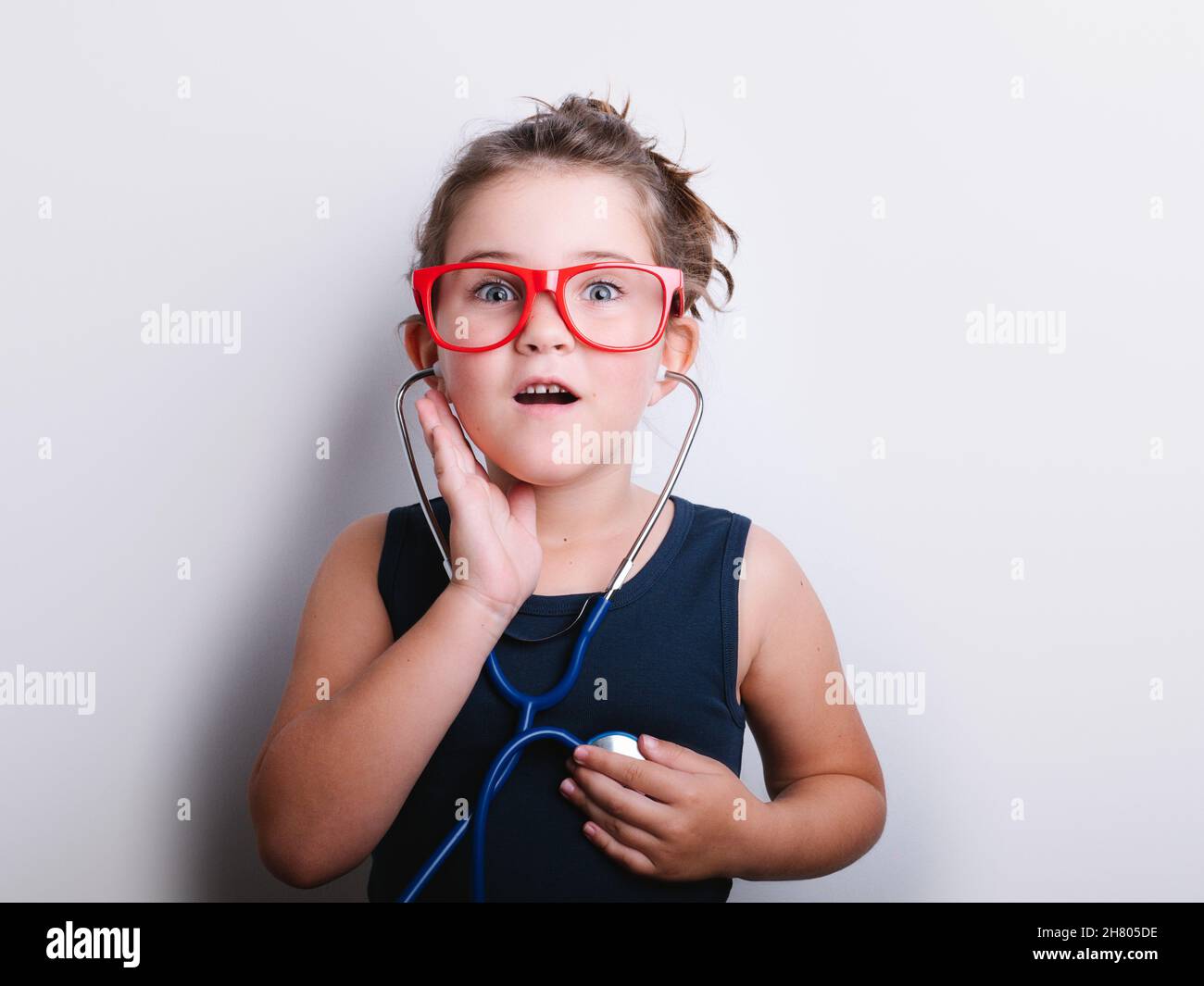 Girl listening heartbeat doctor stethoscope hi-res stock photography ...