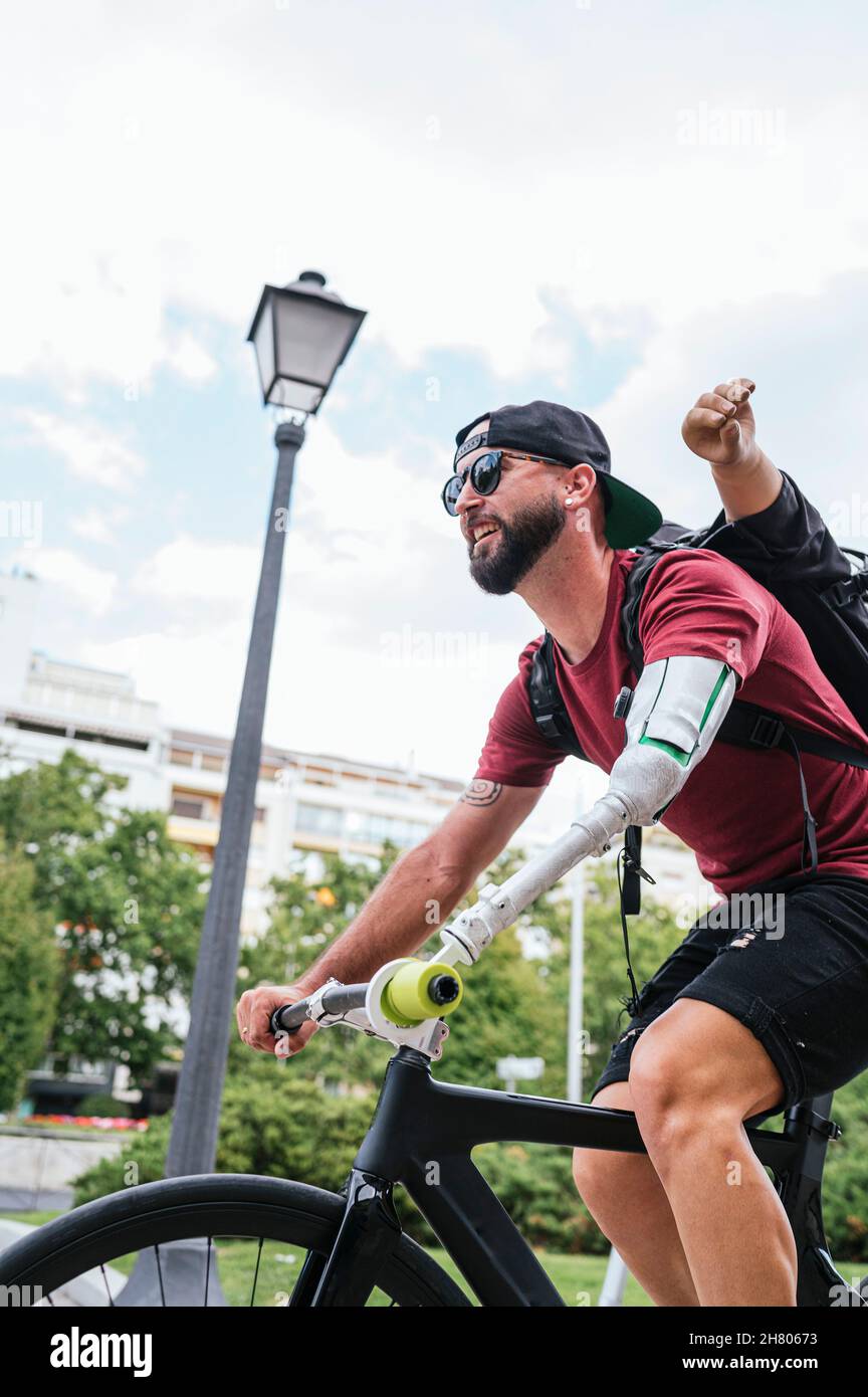 Male shearer using electric machine and shearing fluffy Merino sheep in ...