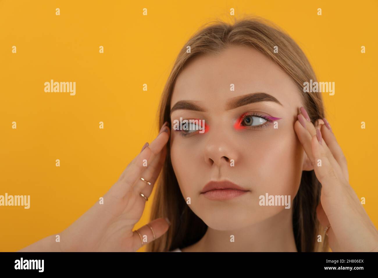 Beautiful model girl with makeup on yellow background Stock Photo - Alamy