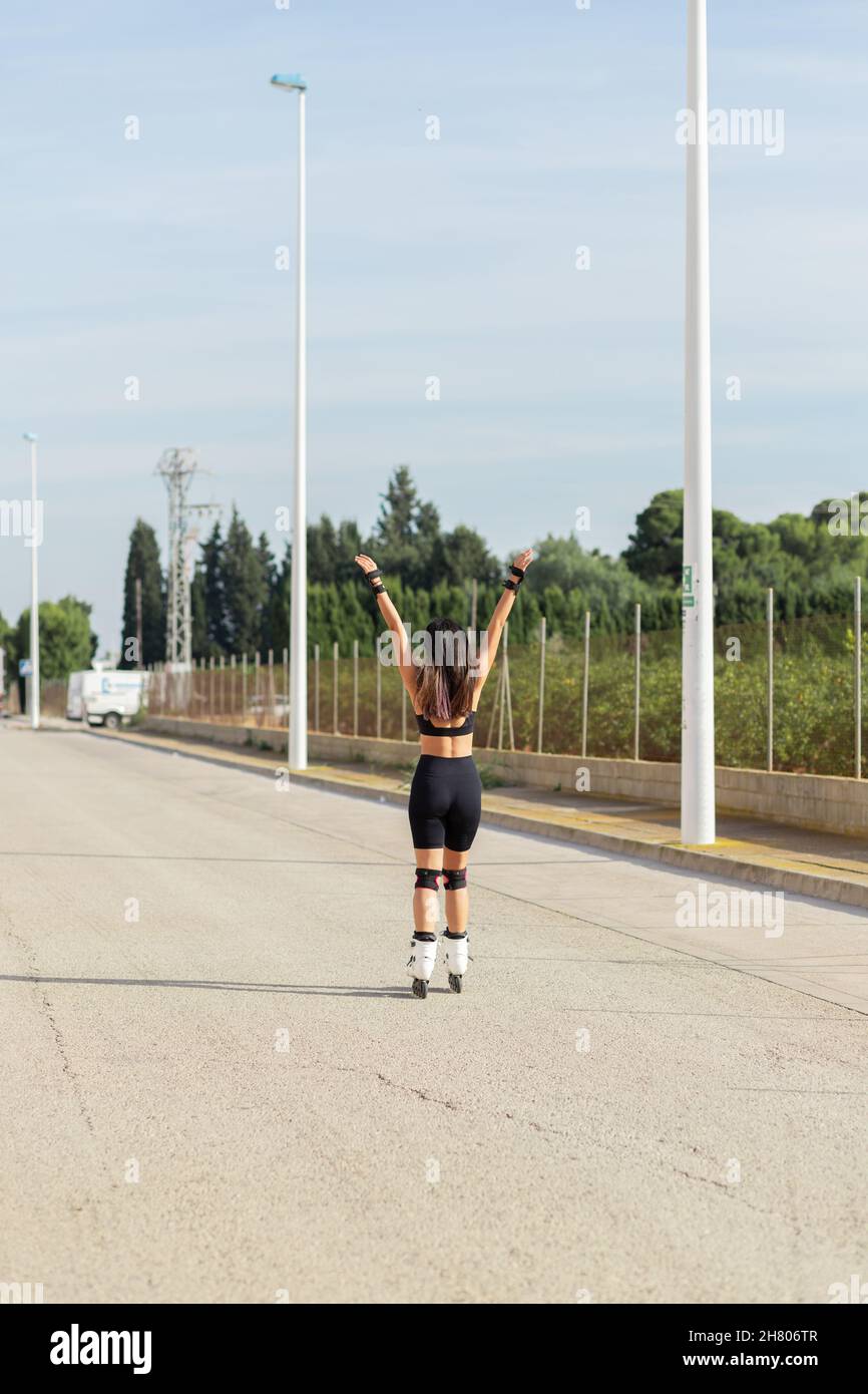 Side view of smiling friends in checkered shirts sitting on bench after ...