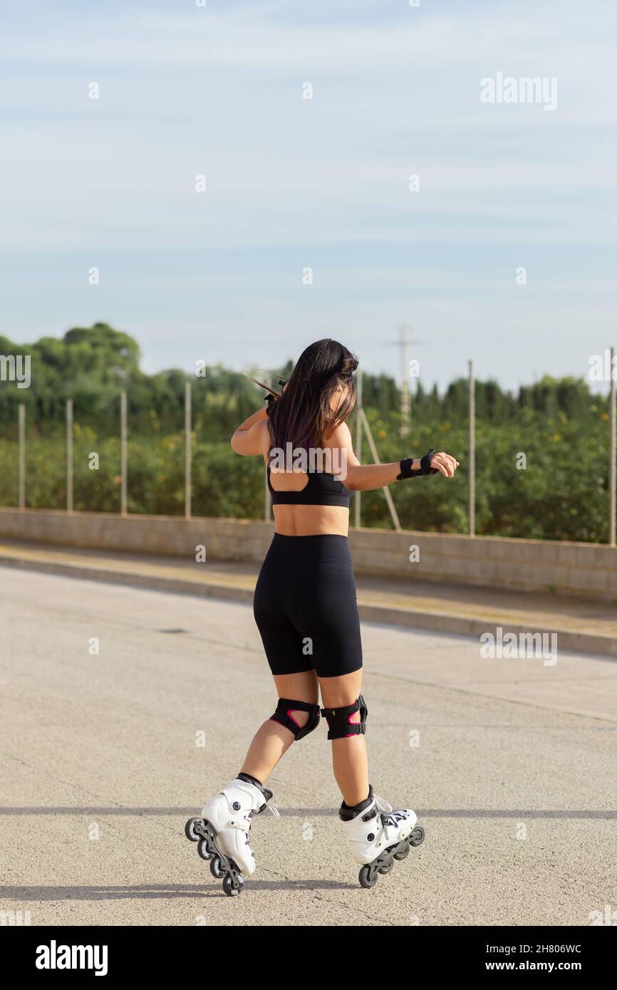 Full body side view of unrecognizable active fit female outstretching ...