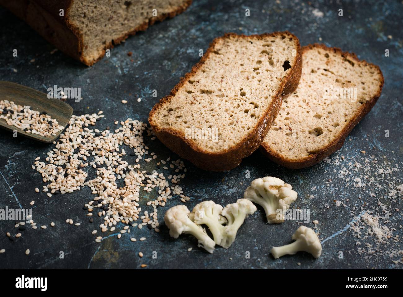 Top view loaf and slices of healthy bread placed on table with spoon in ...