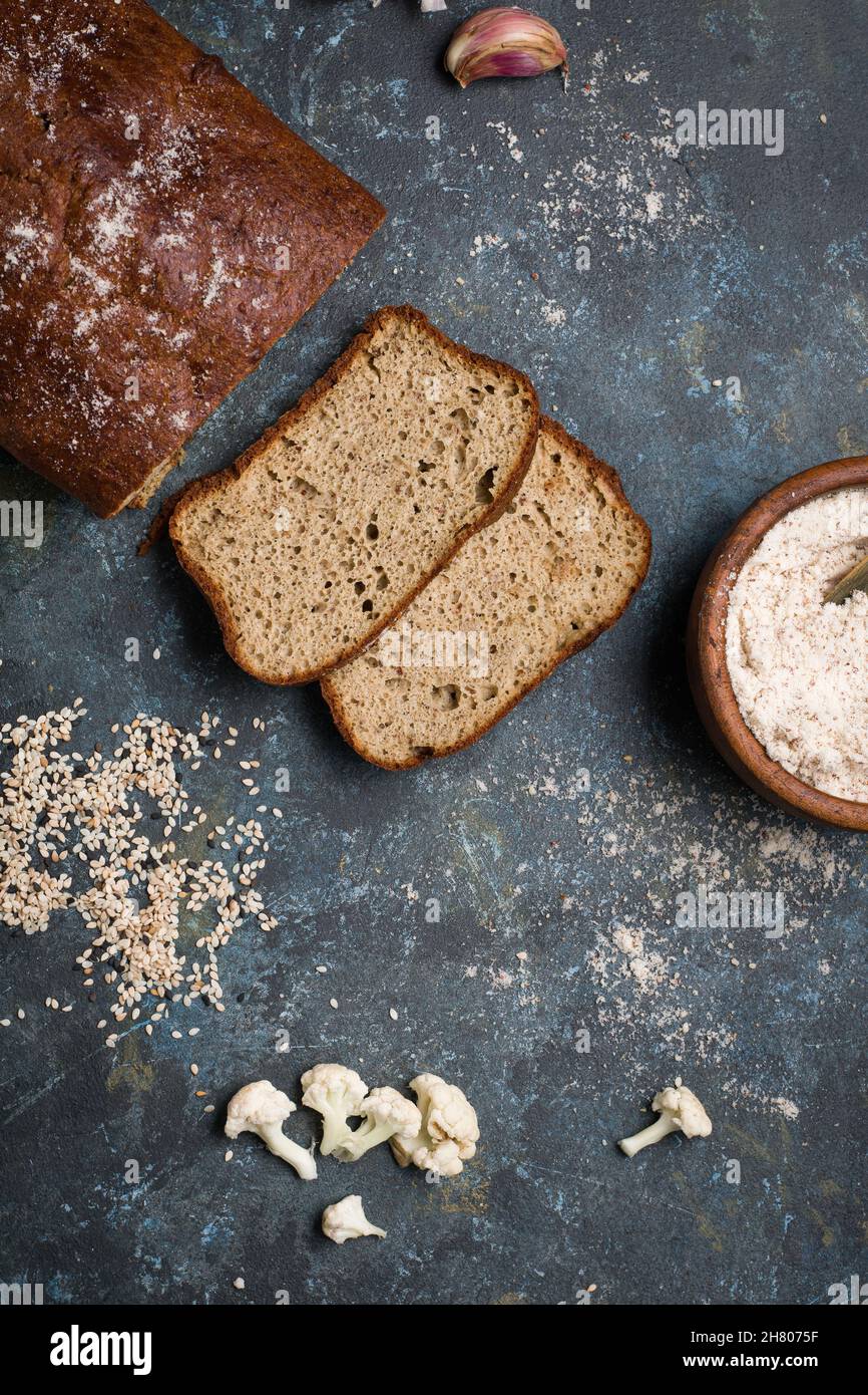 Top view loaf and slices of healthy bread placed on table with ...