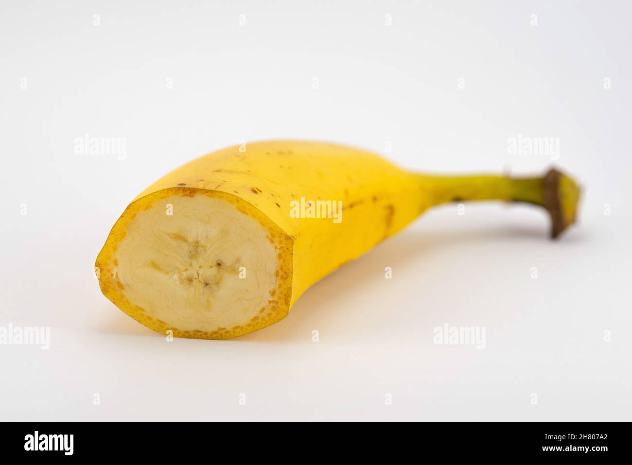 One halved banana on white background Stock Photo - Alamy