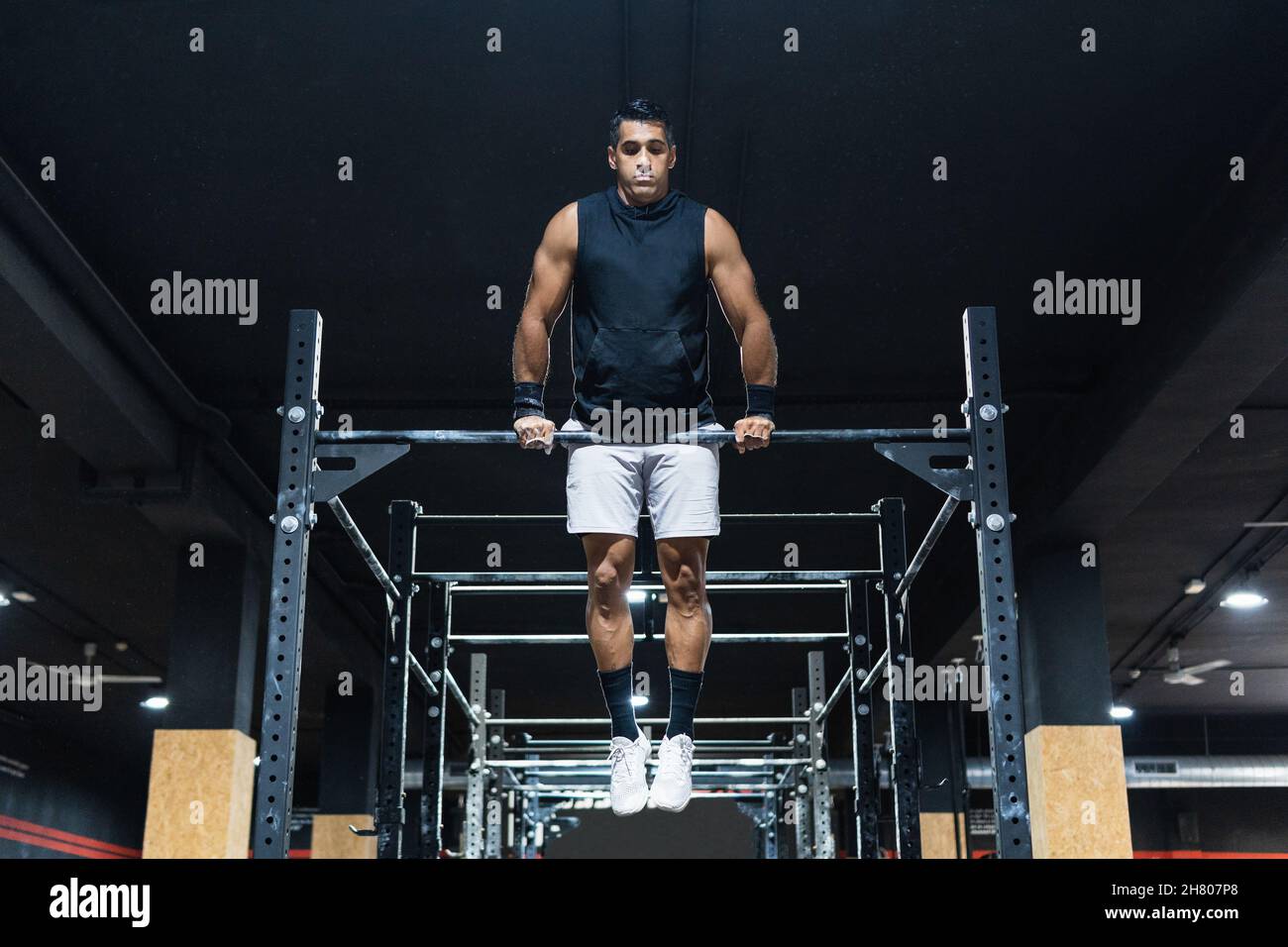 Full body of strong Hispanic male athlete in sportswear doing exercise ...