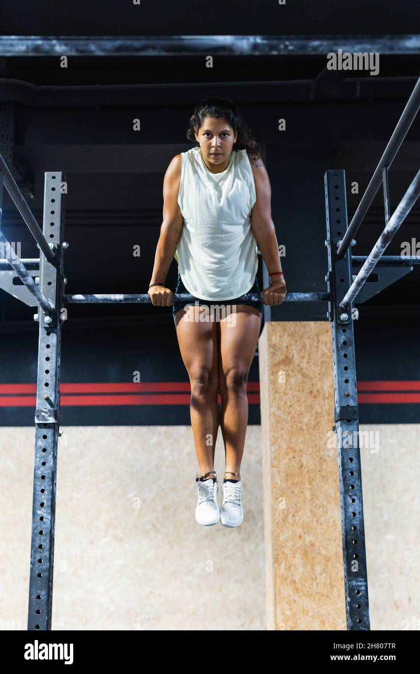 Full body of strong Hispanic female athlete in sportswear doing ...