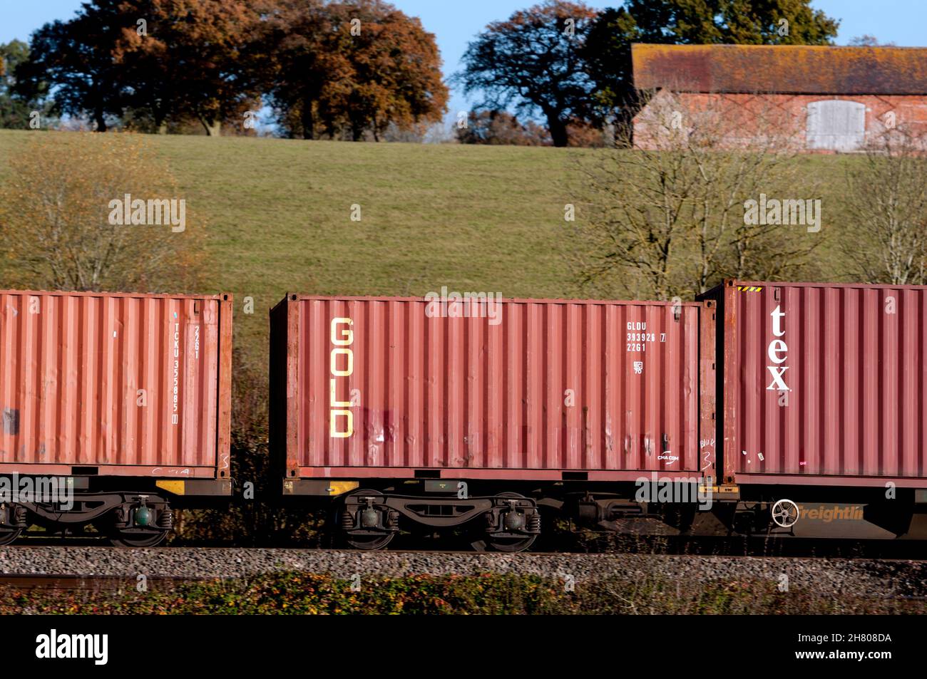 Gold shipping container on a freightliner train, Warwickshire, UK Stock ...