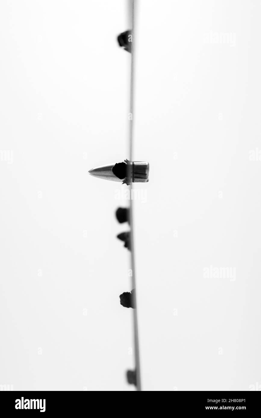 A bullet passing through an obstacle on white background Stock Photo ...