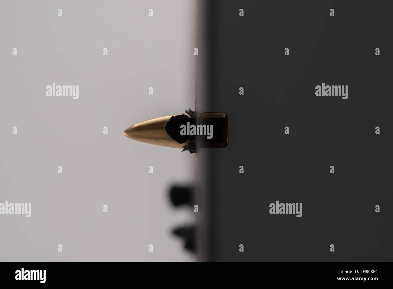 A bullet passing through an obstacle from darkness to light in macro ...