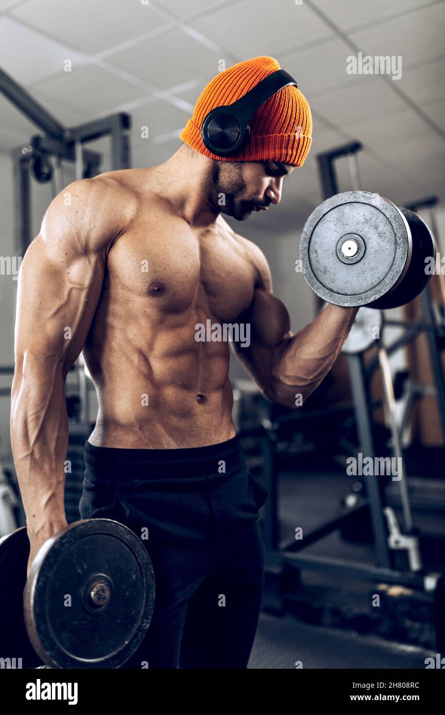 Strong confident muscular Hispanic male athlete listening playlist in ...